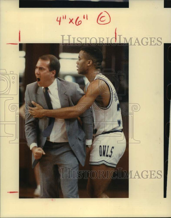 1988 Press Photo Rice's Ronald Robertson holds back coach Scott ...