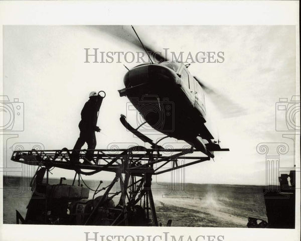 1968 Press Photo Helicopter lifts drill to site on Melville Island ...