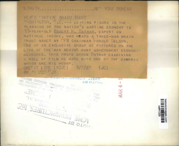 1942 Press Photo Robert R. Nathan Examining Roll of Film - nef41329 ...