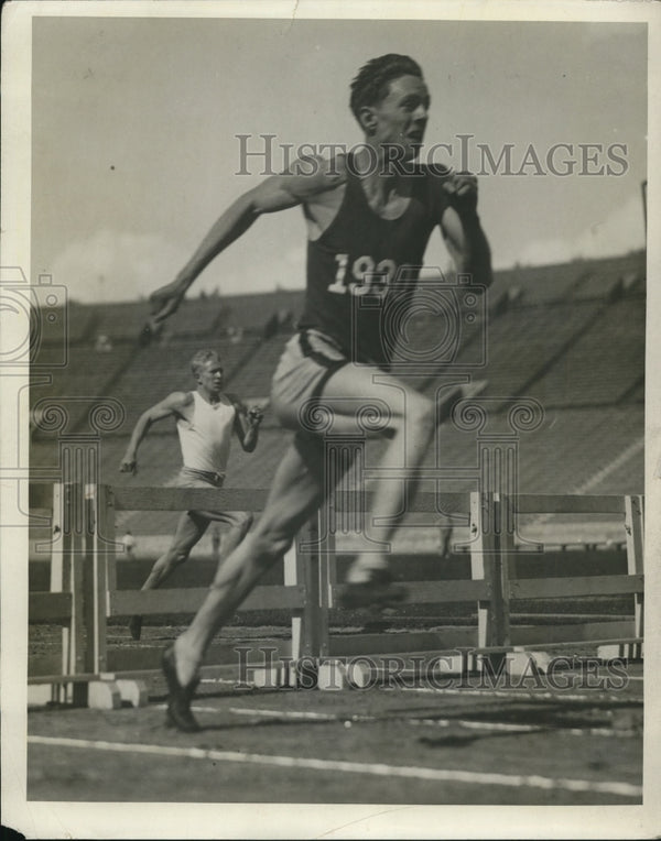 1928 Press Photo Track sprinter clears hurdles in a race at a meet ...
