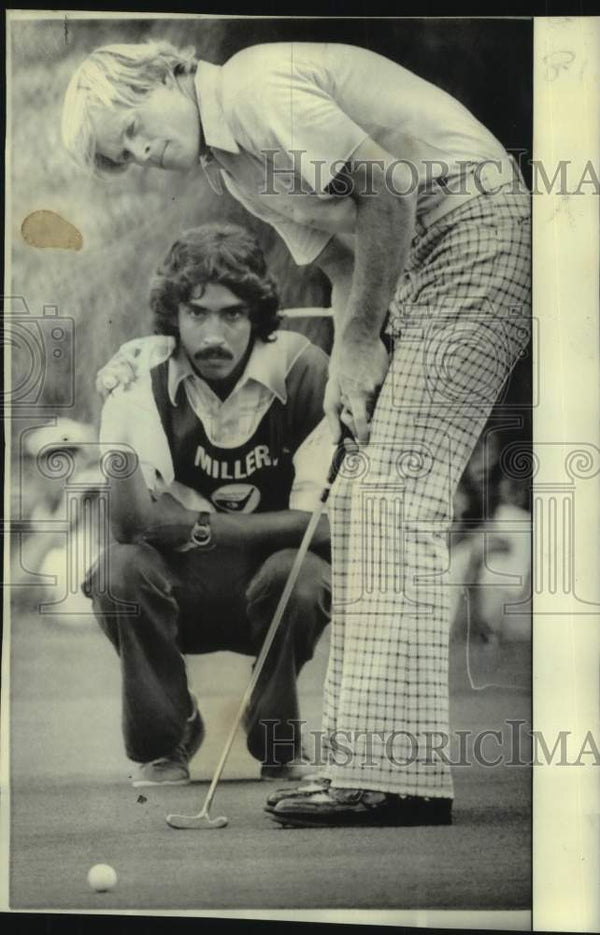 1974 Press Photo Golfer Johnny Miller and his caddy Andy Martinez watch ...