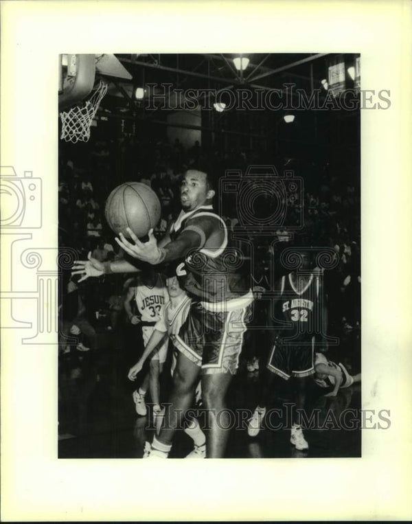 Press Photo St Augustine basketball player Maurice Robertson grabs ...