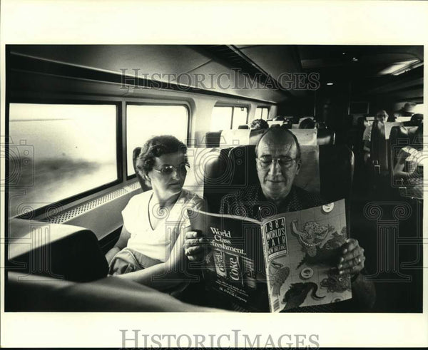 1984 Press Photo Jim and Jean Dover read World Fair book on way to New ...