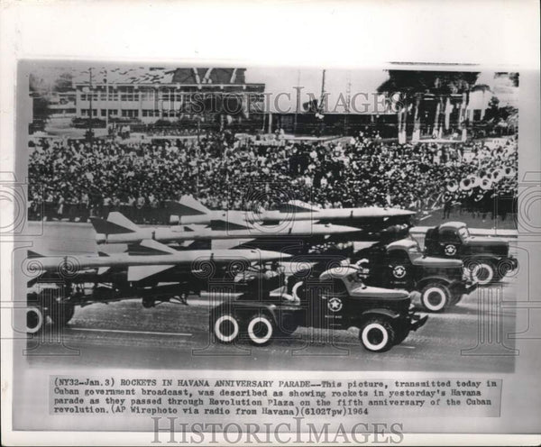 1964 Press Photo People watch vehicles carry rockets during a parade in ...
