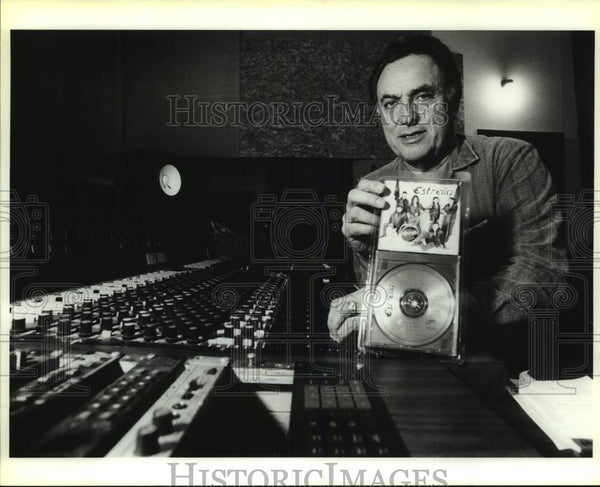 1992 Press Photo Joey Lopez Sr. displays a CD by the band Estrella in ...
