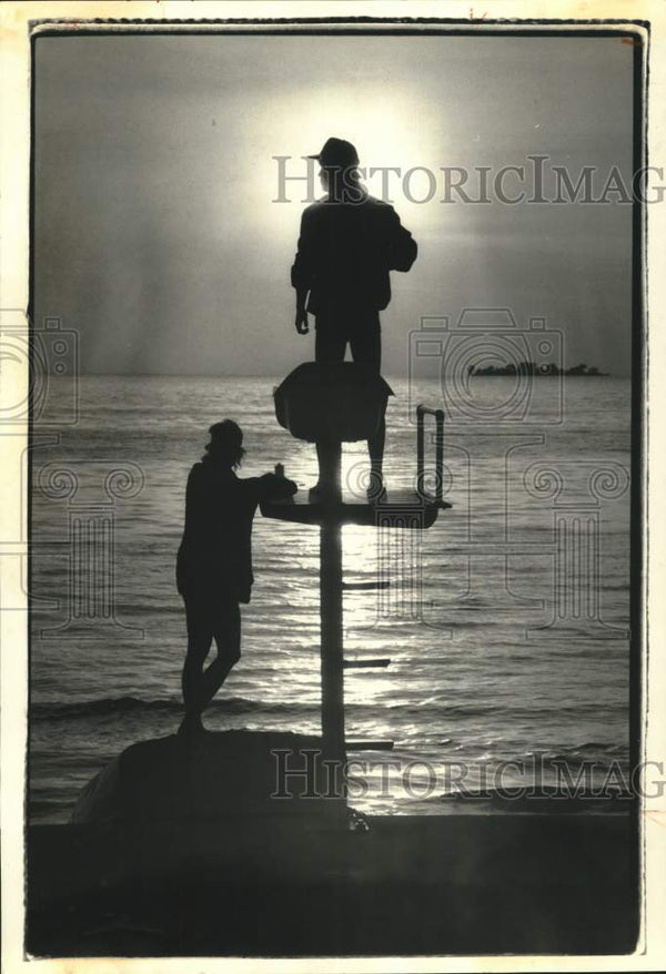 1985 Press Photo Silhouettes of Lifeguards, Mary Bates and Chris Clark ...