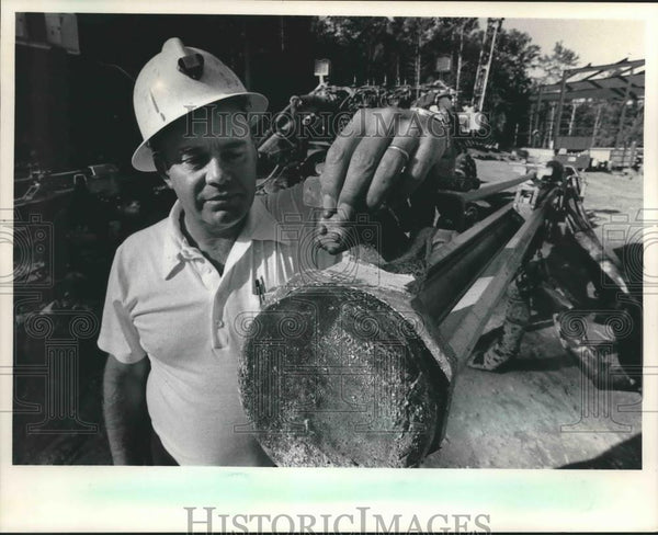 Director of Mining Albert C. Walkup checks bits at Bell Calahan, 1983 ...
