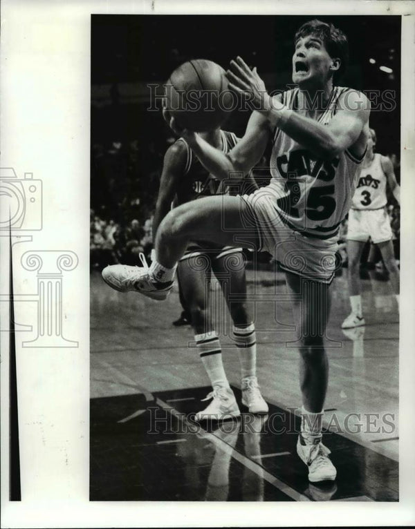 Press Photo Mark Price of the Cavs is thrown off balance after being f ...