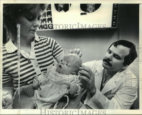 Jessica Zillmer held by mother Suzanne Hanson with Roger Mixter, 1985 ...