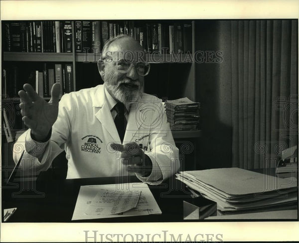 Charles Junkerman, an internist sitting at his desk., 1988 vintage ...