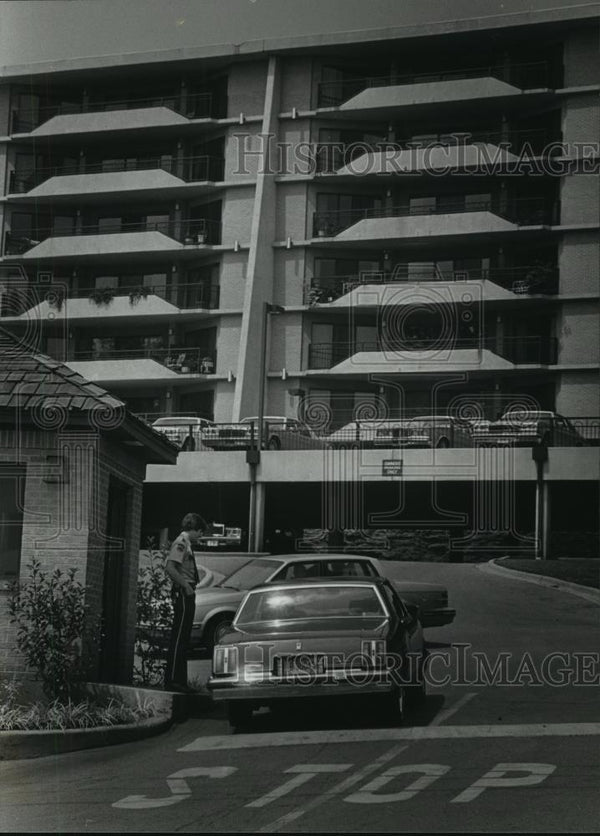 Security guard chats with driver entering Regency Crown Condos, 1982 ...