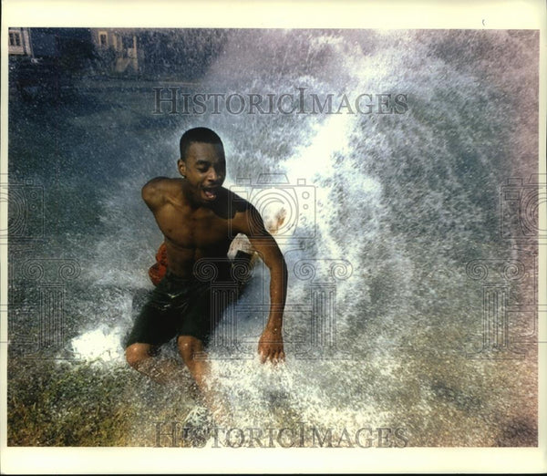 youth plays in fire hydrant spray in Wisconsin, 1993 vintage press ...