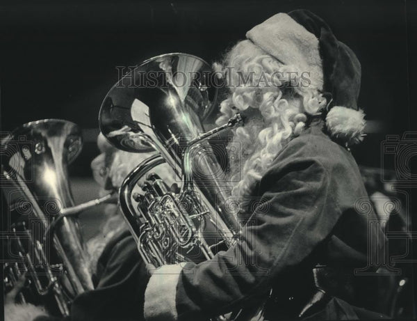 Tuba player dressed as Santa at Tuba Christmas, 1986 vintage press ...