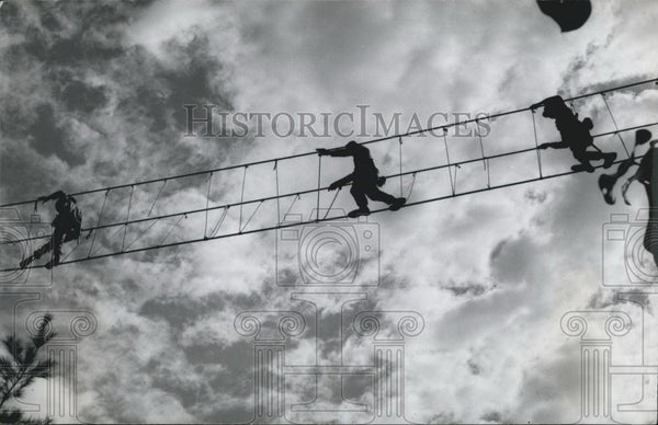 Press Photo troops traverse a ravine on the three rope bridge ...