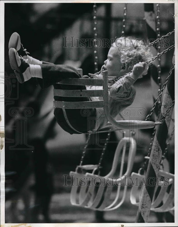 Toddler sits on a swing to play in Omaha, Nebraska 1971 Vintage Press ...