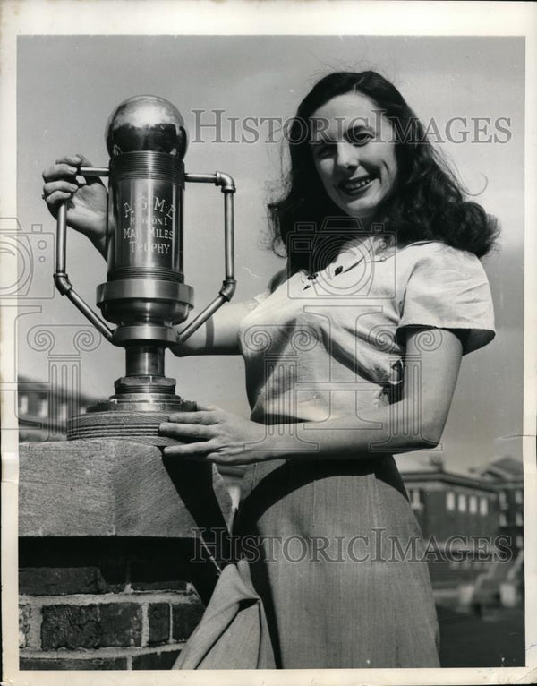Lila Williams holding the Man Miles Trophy developed by the 1950 ...