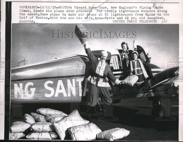 1957 Press Photo Ed Snow Flying Santa Clause Loads Plane With Presents ...