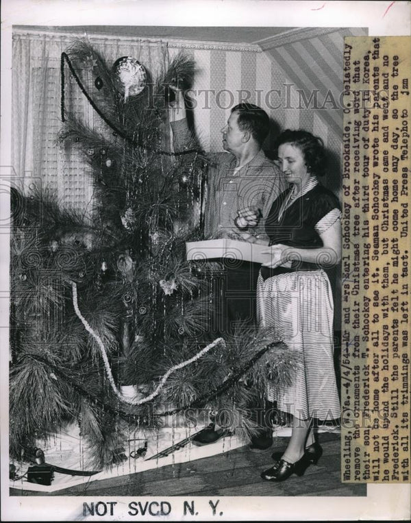 Mr & Mrs Earl Schockey removes ornaments from Christmas tree 1954 ...