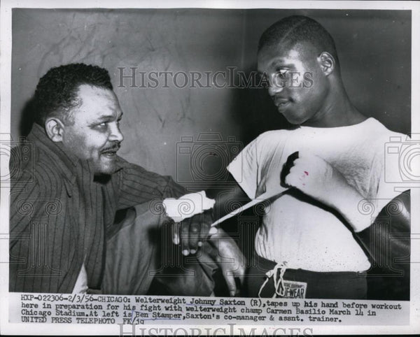 Boxer Johnny Saxton tapes up hands with co-manager Ben Stamper 1956 ...