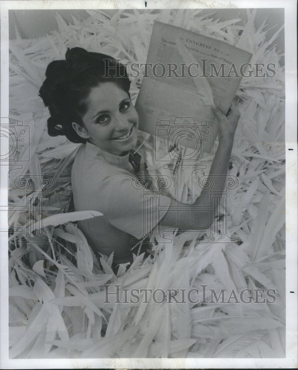 1969 Stewardess sits in nest of quill pens - Historic Images