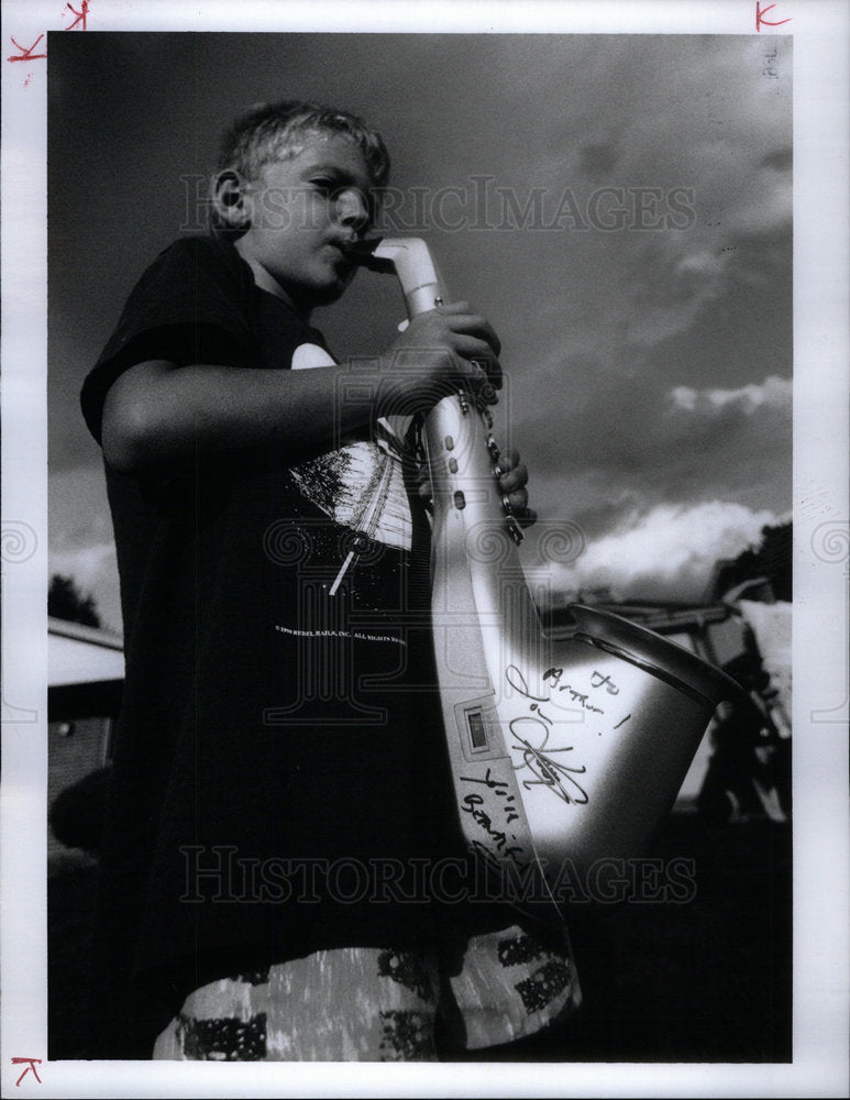 1990 Arthur Lewis plays Saxophone, a gift. - Historic Images