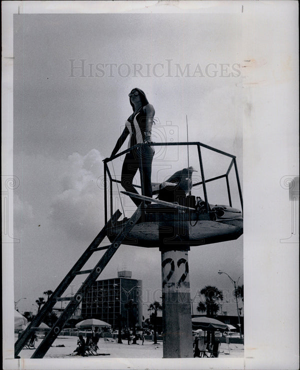 1975 Press Photo Pretty Lifeguard in Striped Swim Suit Standing on Bea ...