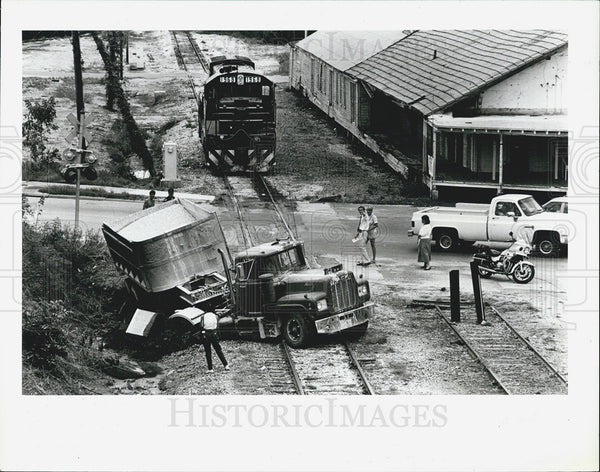 Rock truck straddles tracks after colliding w/ train engine 1987 ...