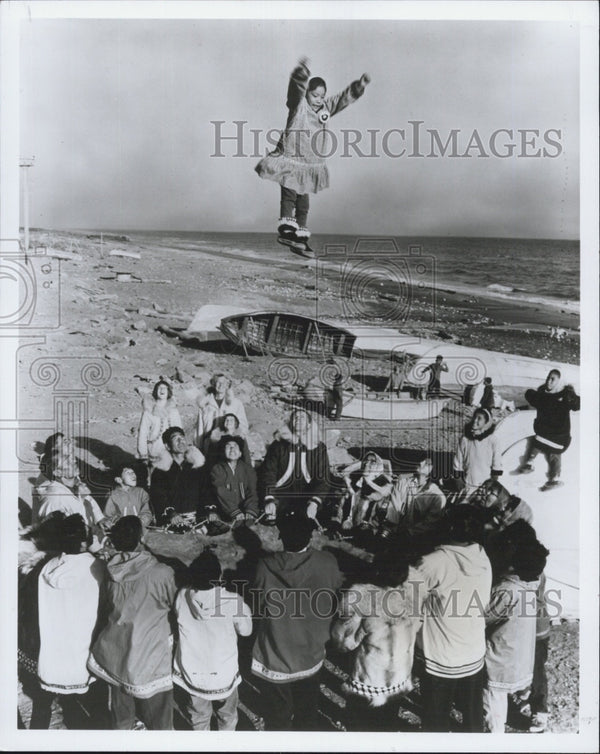 Press Photo Young Eskimo girl flies high on the trampoline - Historic ...