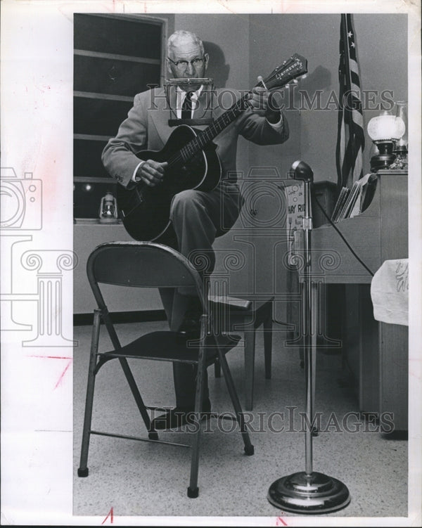 1963 Pastor William Munk playing guitar - Historic Images