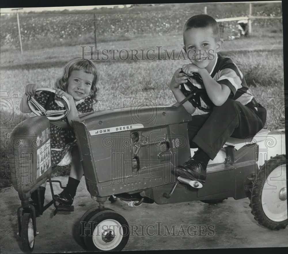 1963, Carol Ann & Jimmy Patterson on toy tractors, Madison County, AL ...