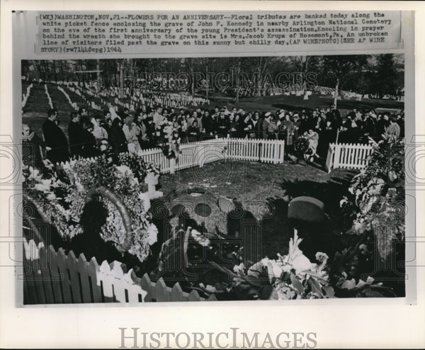 1964 Press Photo Floral Tributes are banked along the white picket fen ...