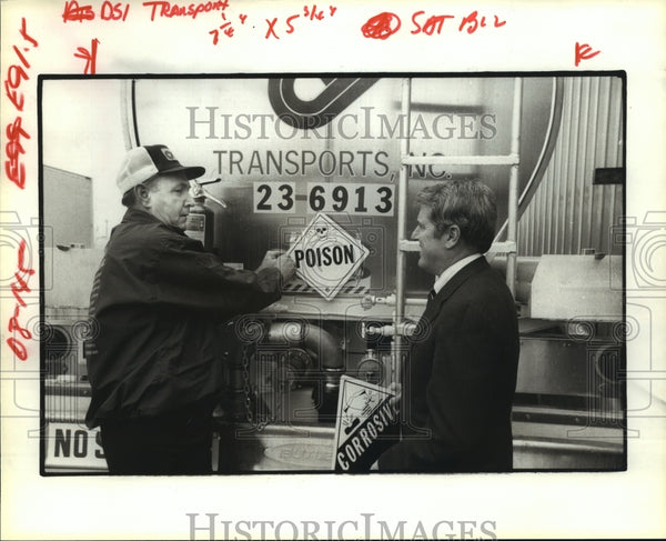 1979 Harold Scott & Ted Gaylor of DSI affix hazardous sign to truck ...