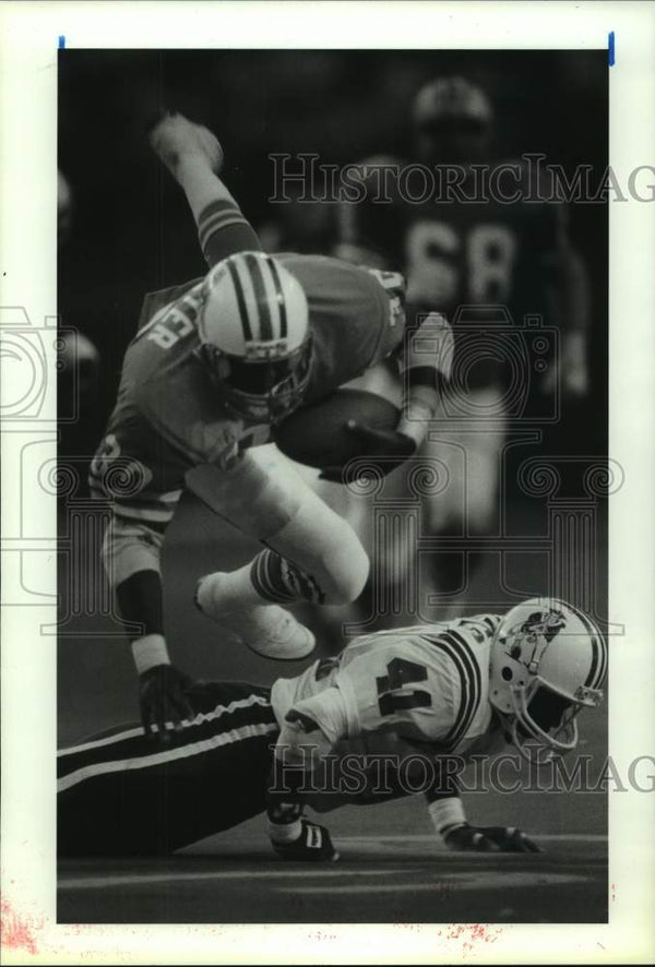 1987 Press Photo Oilers' Herman Hunter is tripped up by Patriots' Darr ...