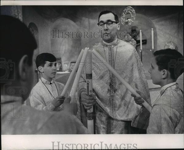 1966 The Rev. E.N. Vergis demonstrates the lightnings of candles ...