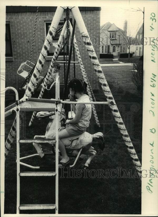 1987 Jessica and Dustin Gossage play on a swingset - Historic Images