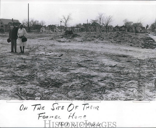 1971 Mr. & Mrs. Irvin Howard stand at site of their previous home ...