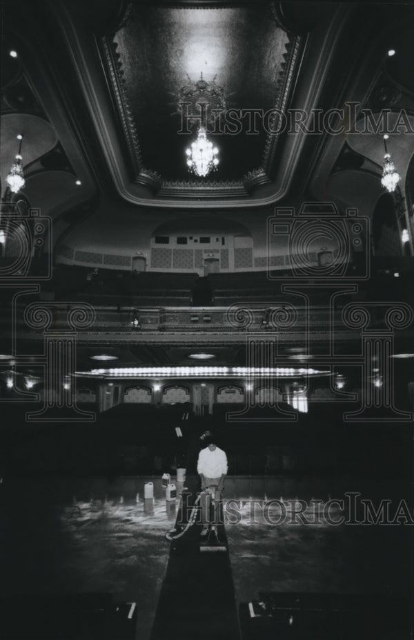 1994 Lou Moreno cleans a rug at the Riverside Theater - Historic Images