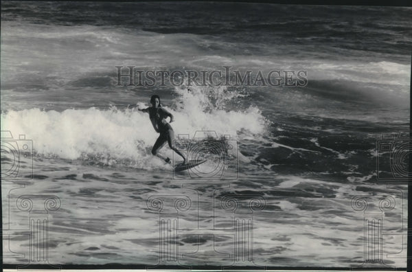 1986 Terry Koper, surfer riding a wave on remote beach, Hawaii ...