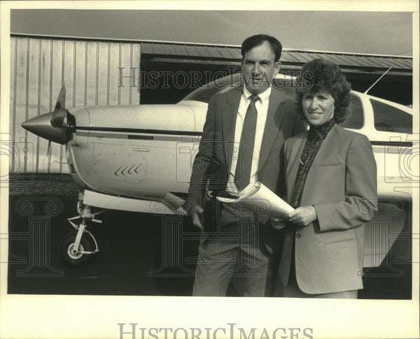 1987 Owners Julie and Jim Peck front of airplane, Management Search ...