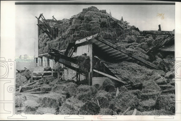 1963 Press Photo Donald Flannery farm leveled by tornado, hay in open ...