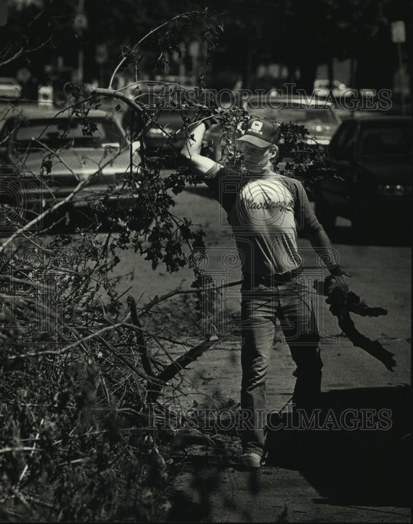 1990, Larry Price clears branches along East Avenue, Waukesha ...