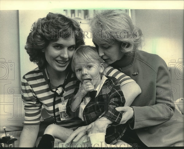 1985, Michael Troche gets hug from nurse Kristi Kirk & his mom, Judy ...