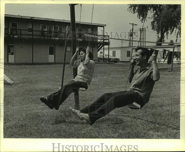 1979 Migrant Workers at Texas Camp, Belgium relax on swings - Historic ...