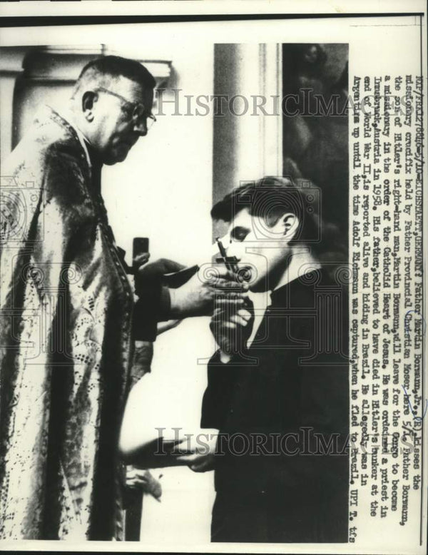1961, Father Martin Bormann kisses the crucifix of Father Moser ...