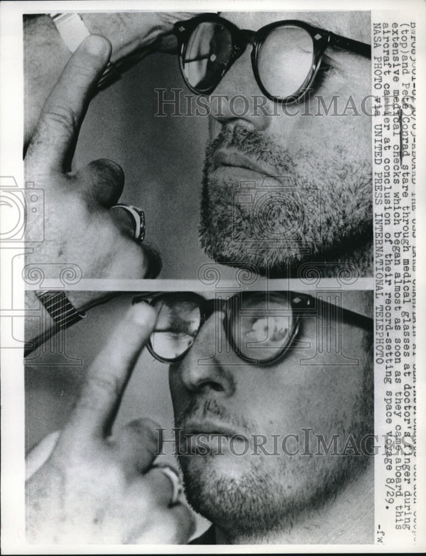 1965 Pete Conrad gets med check after space flight - Historic Images