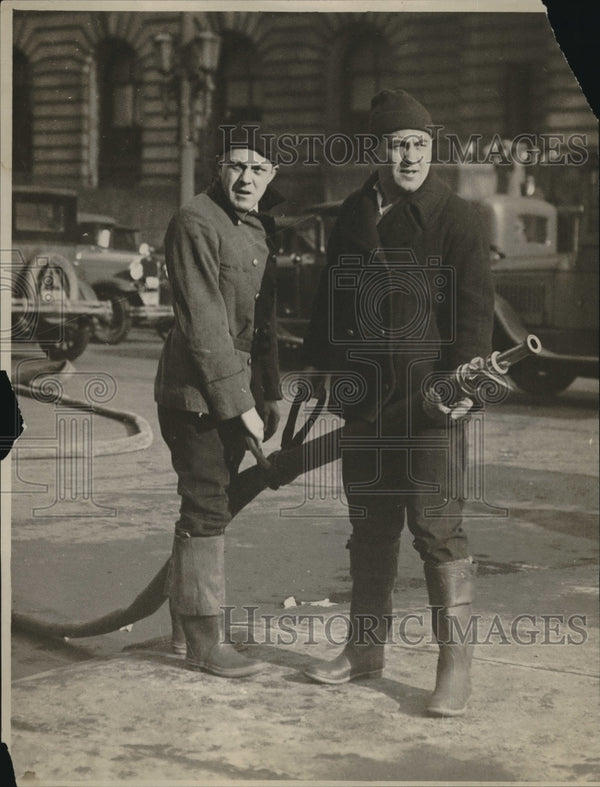 1930 Two firefighters using fire hose - Historic Images