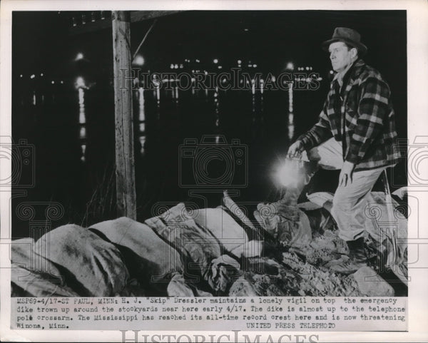 1952 H. J. "Skip" Dressler is on vigil on emergency dike - Historic Images