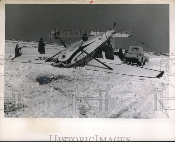 1954 Group of men turnaround the inverted plane in Lakefront Airport ...