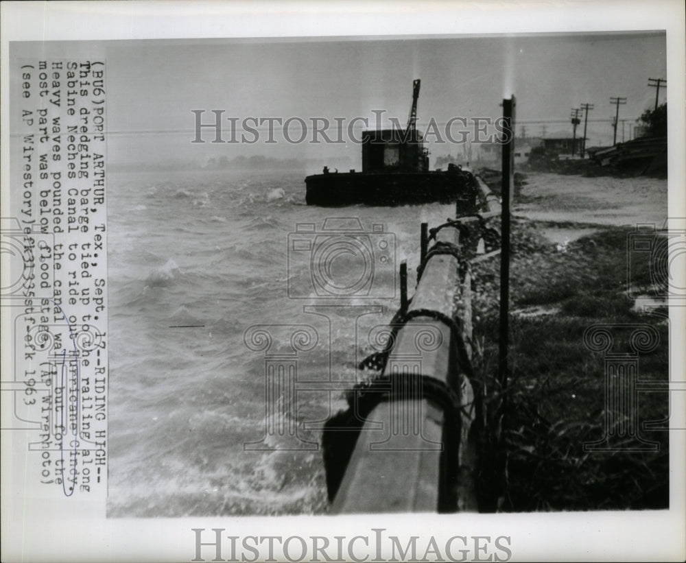 1963 Press Photo Hurricane Cindy- Dredging barge tied up to railing ...
