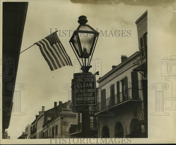 1962 Press Photo The flag flies over a public service sign on Flag Day ...